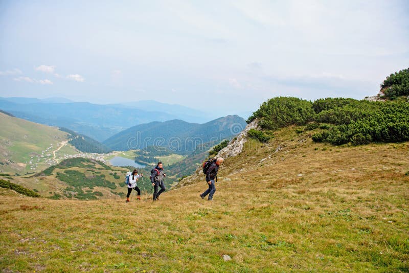 An Elderly Man Giving a Tour for a Young Group of People Stock Image ...