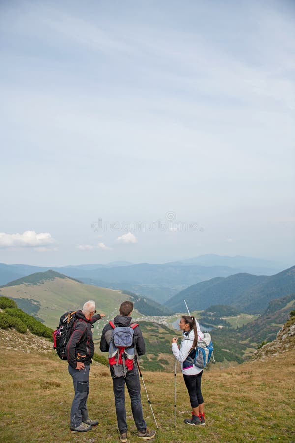 An Elderly Man Giving a Tour for a Young Group of People Stock Photo ...