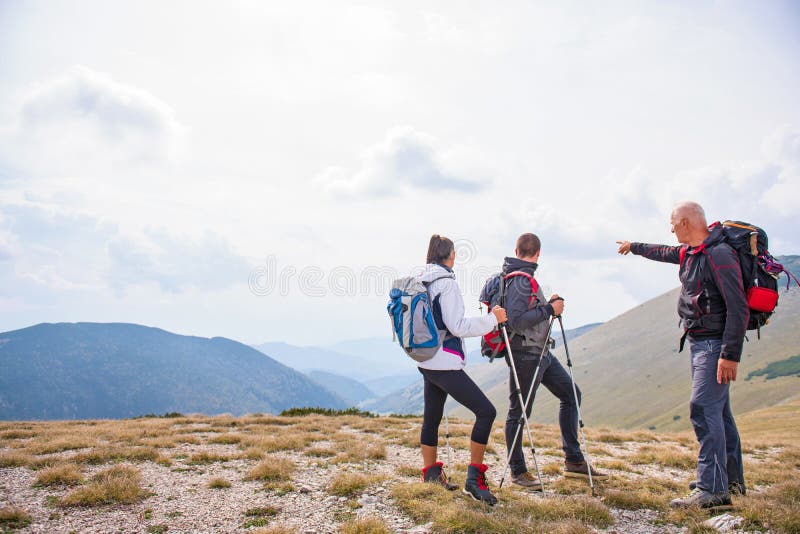 An Elderly Man Giving a Tour for a Young Group of People Stock Image ...