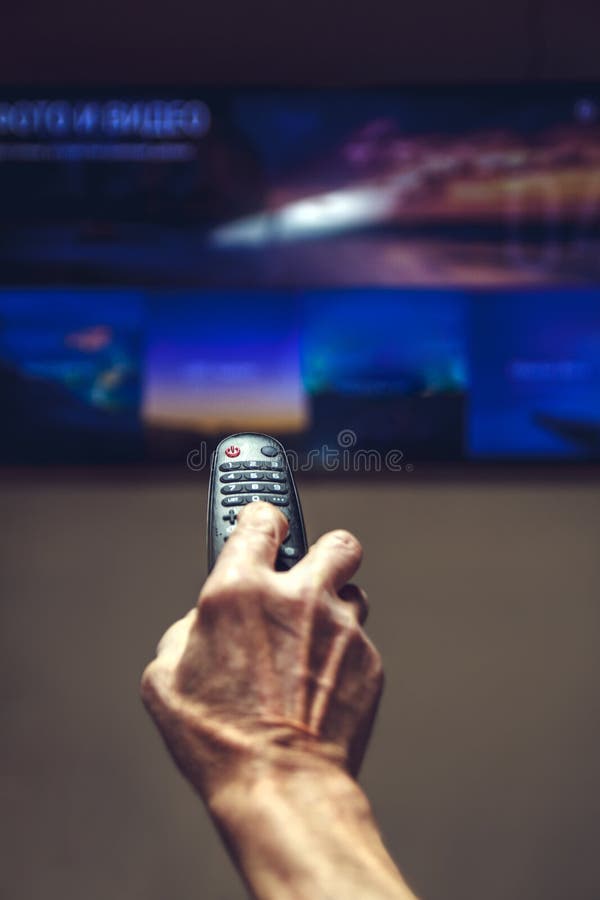 Elderly Man Hand Holding TV Remote Control. Stock Image - Image of ...