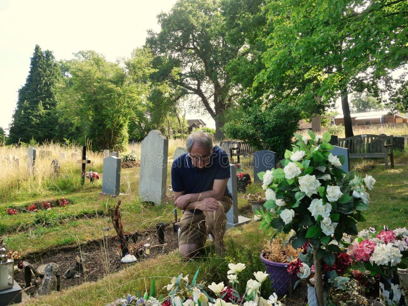Elderly Man Kneeling at a Graveside Grieving Stock Image - Image of ...
