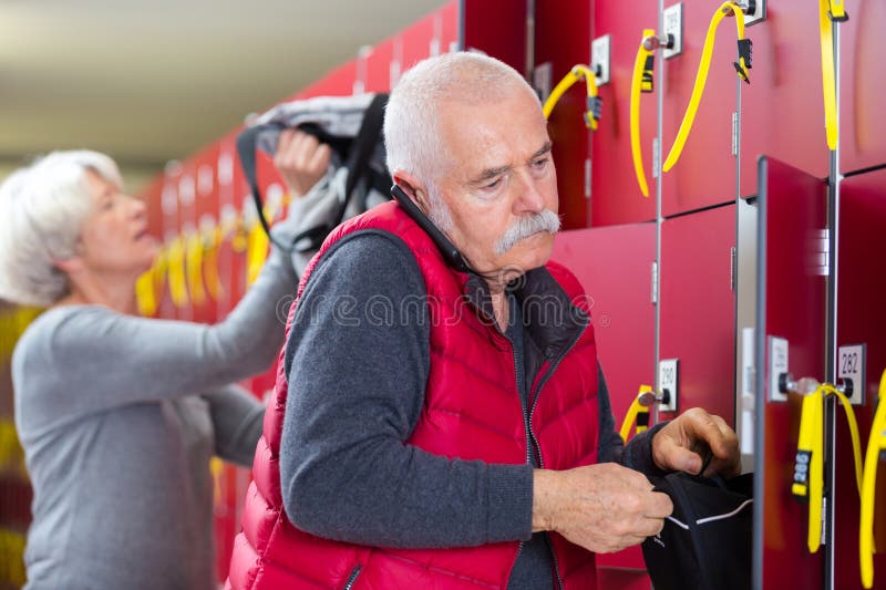 Elderly Man on Phone Taking Belongings Out from Locker Stock Image ...
