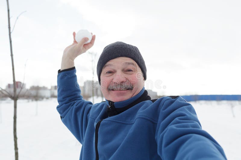An Elderly Man Playing Snowballs Stock Image - Image of handsome ...