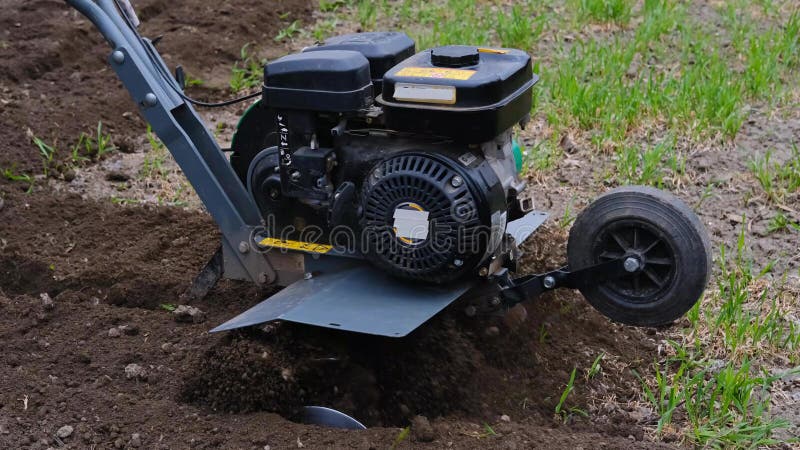 Elderly Man Plows the Soil with a Cultivator or Tillerblock Stock ...