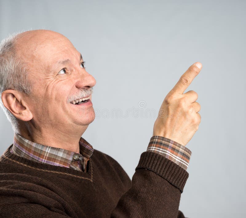 Elderly man pointing up stock photo. Image of male, lifestyle - 60730114