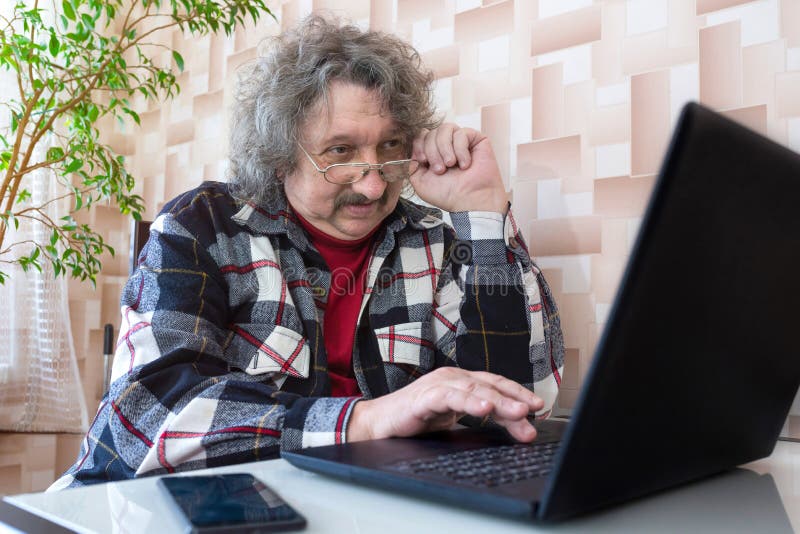 An Elderly Man with Poor Eyesight Working at the Computer, a Close-up ...