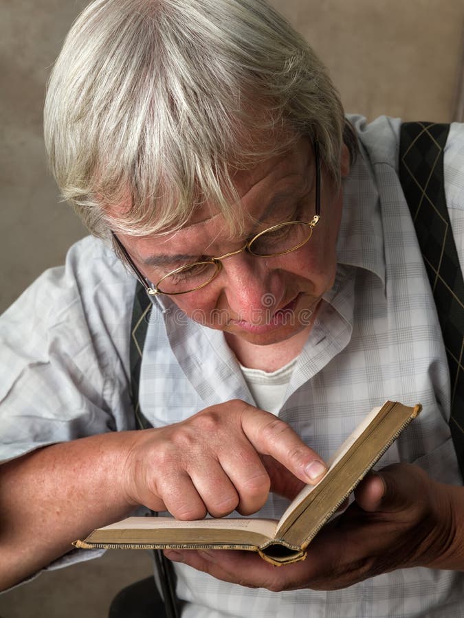 Elderly man reading book stock image. Image of home, glasses - 68560703