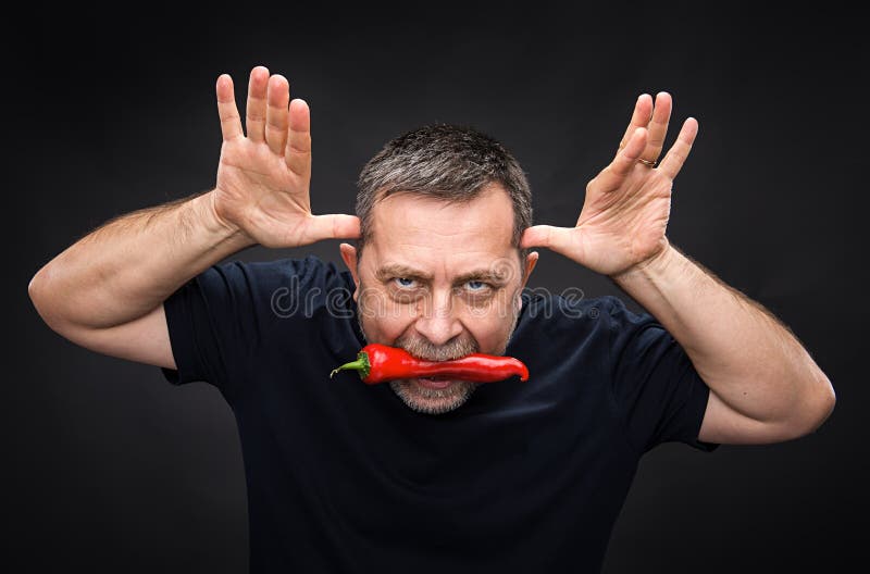 Elderly Man with Red Pepper in His Mouth Stock Image - Image of chilli ...
