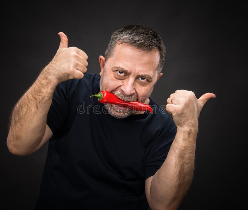 Elderly Man with Red Pepper in His Mouth Stock Photo - Image of ...