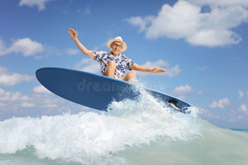 Elderly Man Riding a Surfboard on a Wave Stock Photo - Image of ...