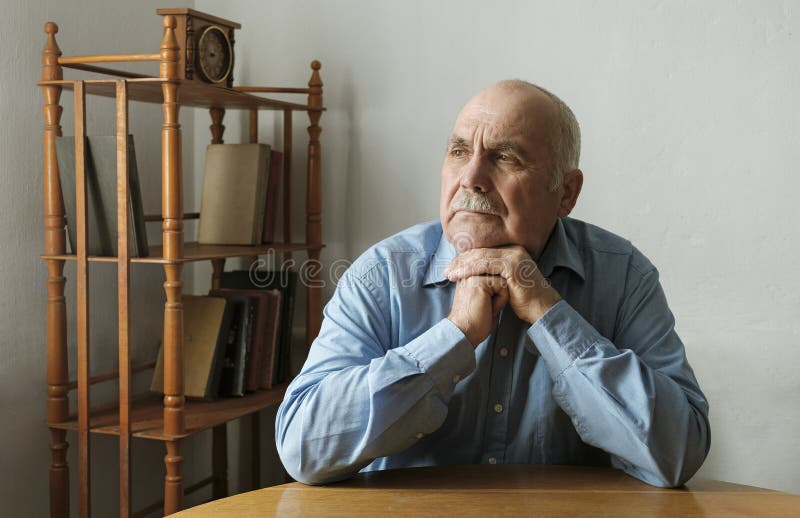Elderly Man Seated at a Table Thinking Stock Image - Image of introvert ...