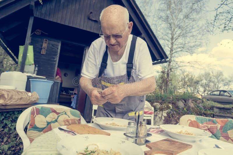 Elderly Man Setting a Table Outside. Stock Image - Image of vintage ...