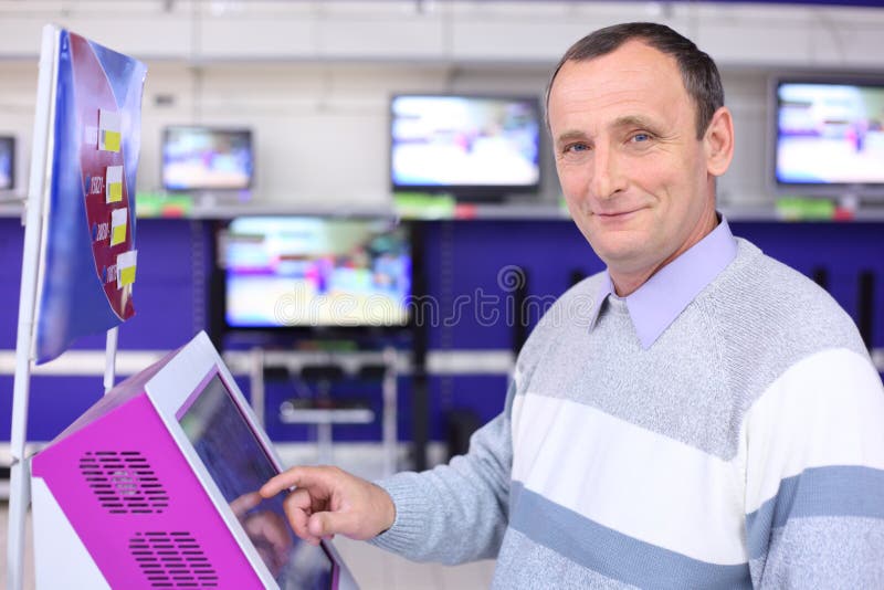 Elderly Man in Shop at Information Screen Stock Image - Image of adult ...