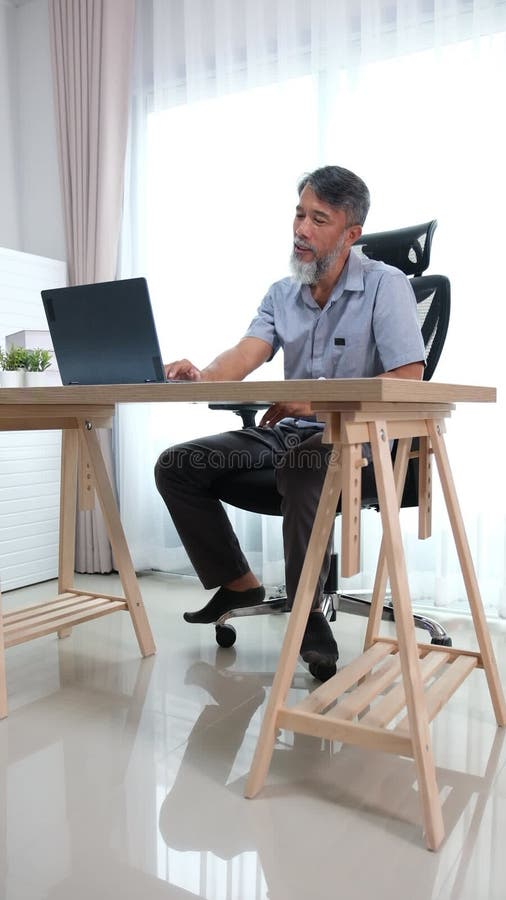 Elderly Man Using Laptop and Taking Notes in His Home Office. Stock ...