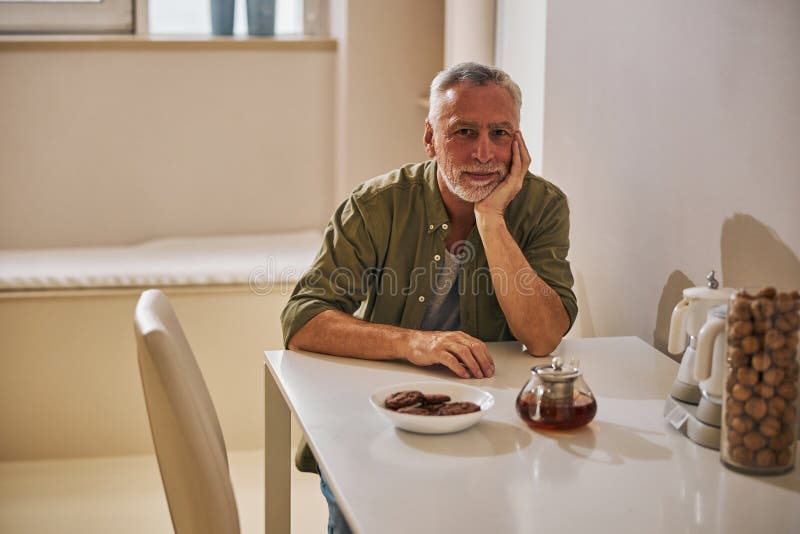 Elderly Man Sitting in His Minimalistic Kitchen Stock Photo - Image of ...