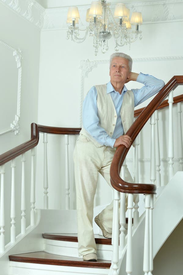 Elderly man on stairs stock image. Image of interior - 44062915