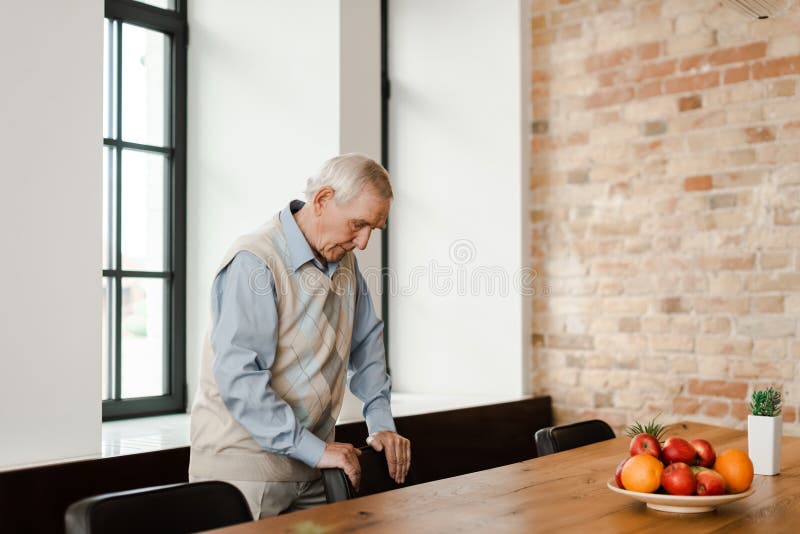 Elderly Man Standing at Table with Stock Image - Image of indoors ...