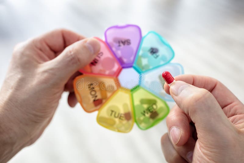 Elderly Man Taking daily Medication from Pill Box Stock Image - Image ...