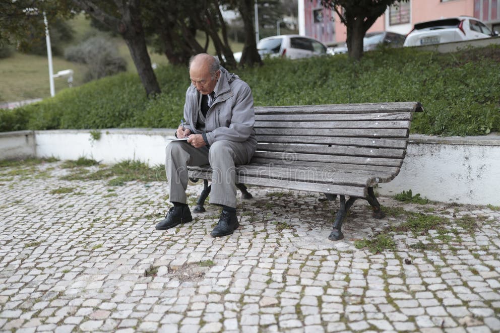 Senior Man Writing Notes while Sitting on Bench in Park Stock Image ...