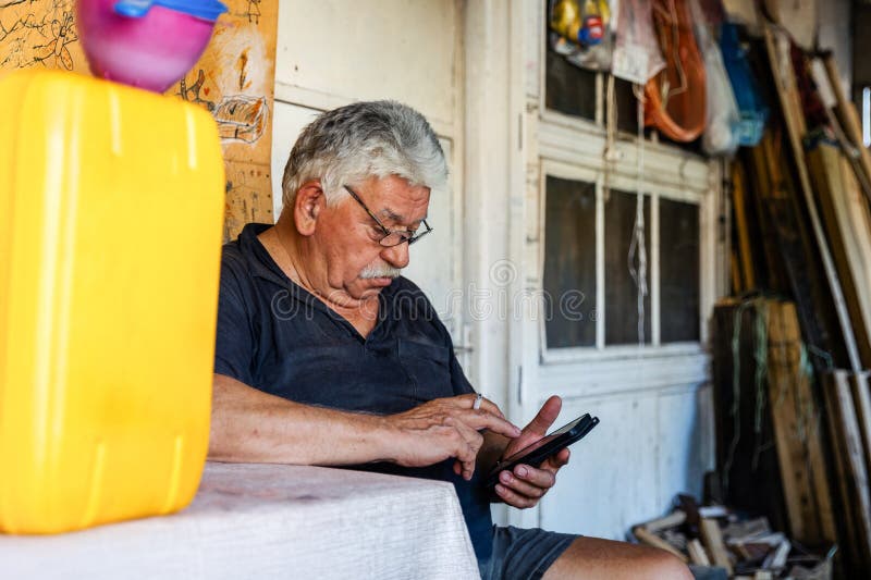 Elderly Man Using Tablet on Rustic Porch Setting Stock Image - Image of ...