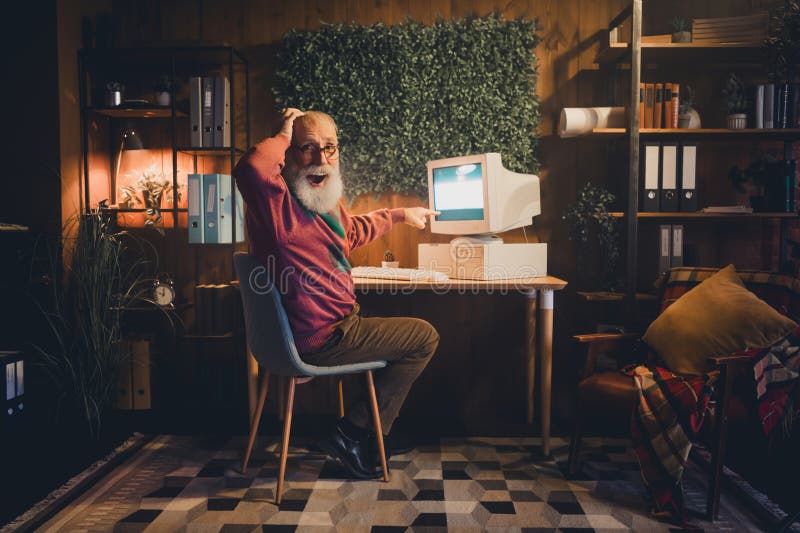 Elderly Man Using a Vintage Computer at Home Office, Surrounded by ...