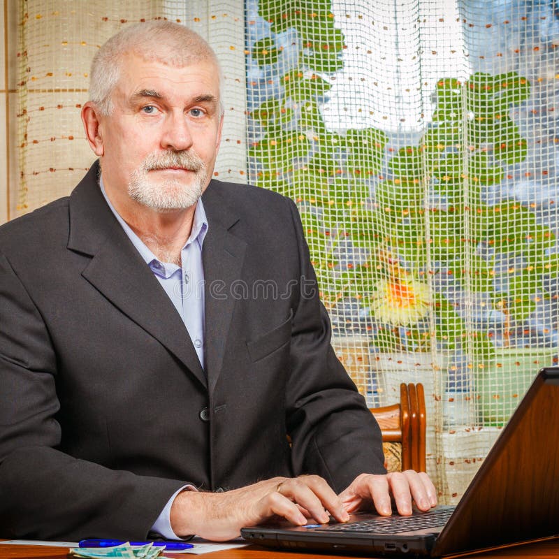 An elderly man is working stock photo. Image of look - 190574598
