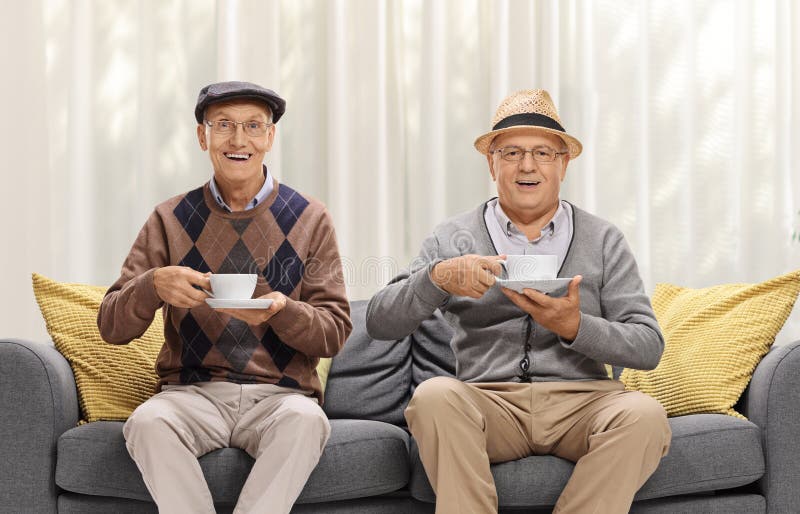 Elderly Men Sitting on a Sofa and Having a Cup of Tea Stock Photo ...