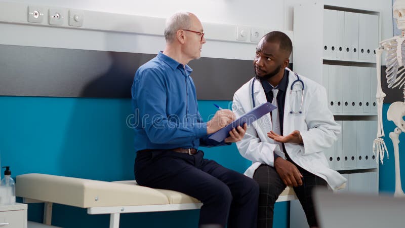 Elderly Patient Signing Consultation Form To Receive Medication Stock