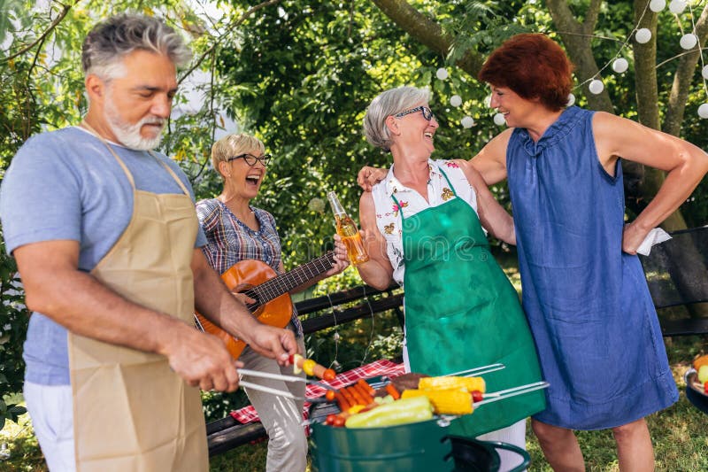 Senior People are Making Barbeque, Drinking Beverages, Making Memories ...