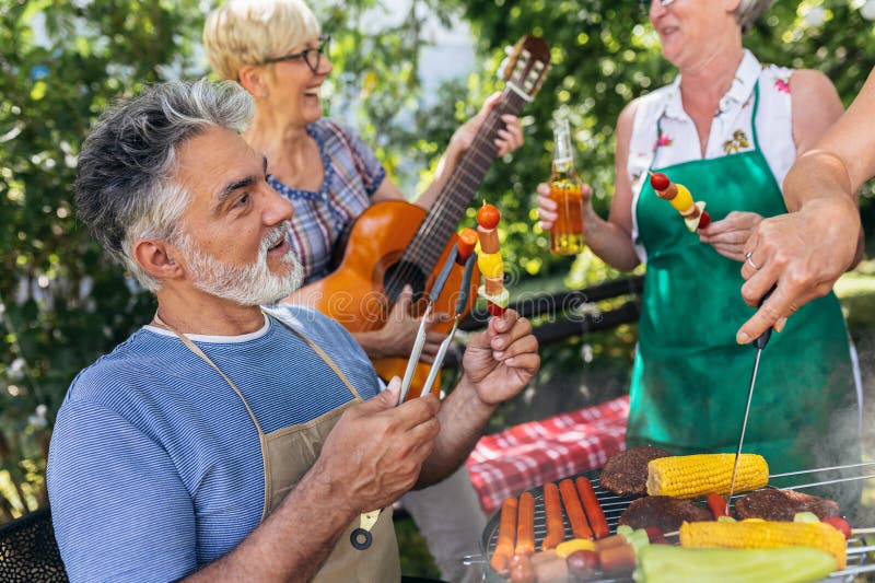 Senior People are Making Barbeque, Drinking Beverages, Making Memories ...