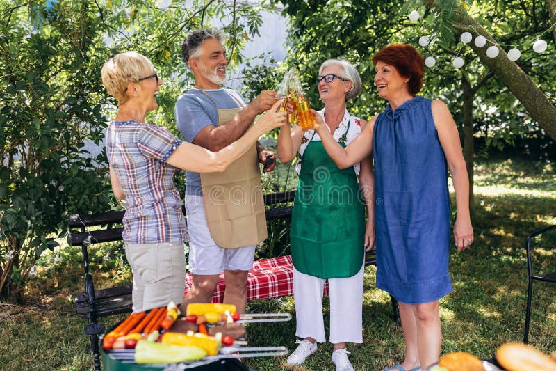 Senior People are Making Barbeque, Drinking Beverages, Making Memories ...