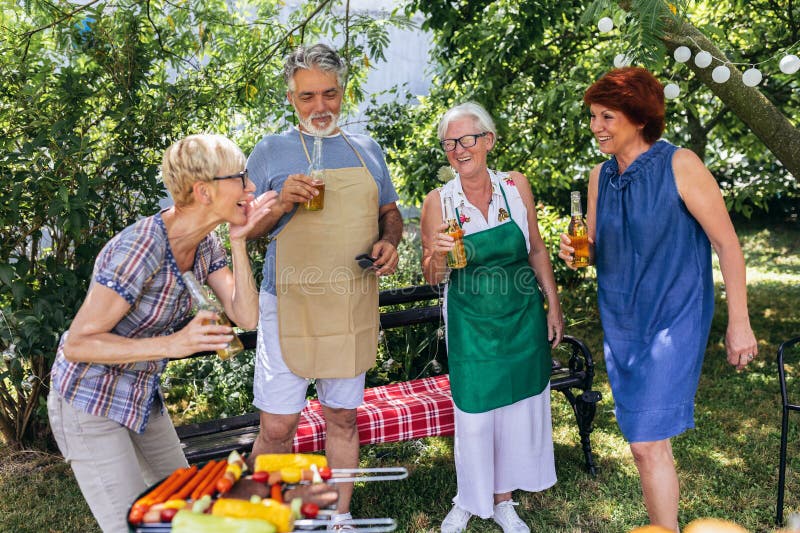 Senior People are Making Barbeque, Drinking Beverages, Making Memories ...