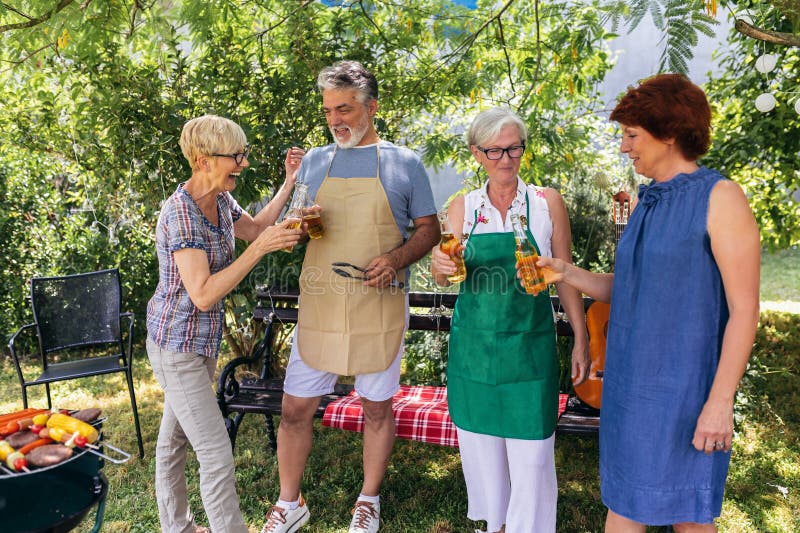 Senior People are Making Barbeque, Drinking Beverages, Making Memories ...