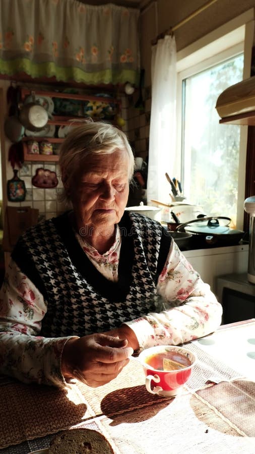 An Elderly Person Enjoys a Soothing Cup of Tea in a Cozy Kitchen Stock ... An Elderly Person Enjoys a Soothing Cup of Tea in a Cozy Kitchen Stock ...