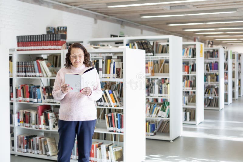Elderly Person Reading a Book in a Public Library Stock Image - Image ...