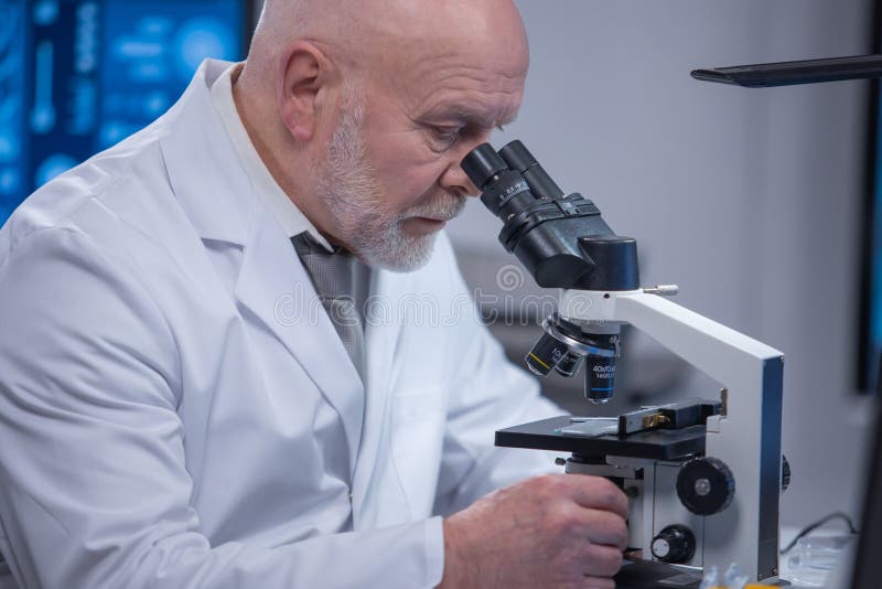 Elderly Professor is Doing a Science Experiment in a Modern Laboratory ...