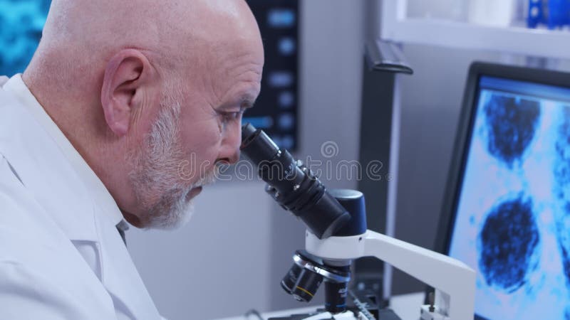 Elderly Professor is Doing a Science Experiment in a Modern Laboratory ...