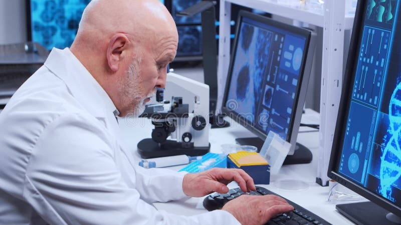 Elderly Professor is Doing a Science Experiment in a Modern Laboratory ...