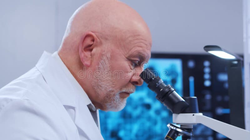 Elderly Professor is Doing a Science Experiment in a Modern Laboratory ...