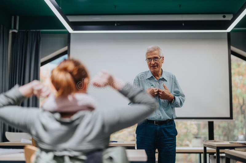 Elderly Professor Engaging with Students in a Modern Classroom Stock ...