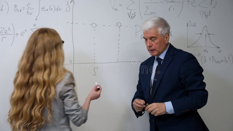Student Explains Graph on Whiteboard To Professor in Classroom Stock ...