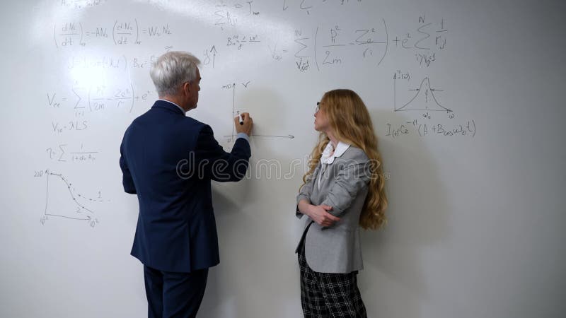 Student Explains Graph on Whiteboard To Professor in Classroom Stock ...