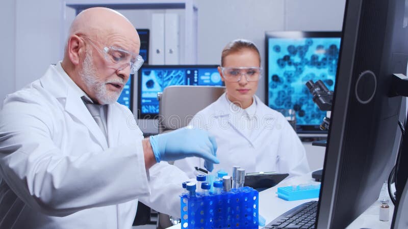 Elderly Professor and Young Laboratory Assistant are Doing Scientific ...