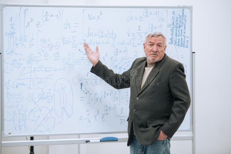 An Elderly Professor of Mathematics Stands in His Office at a White ...