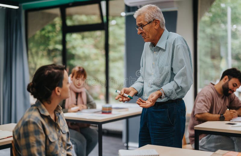 Elderly Professor Teaching Attentive Students in Classroom Setting ...