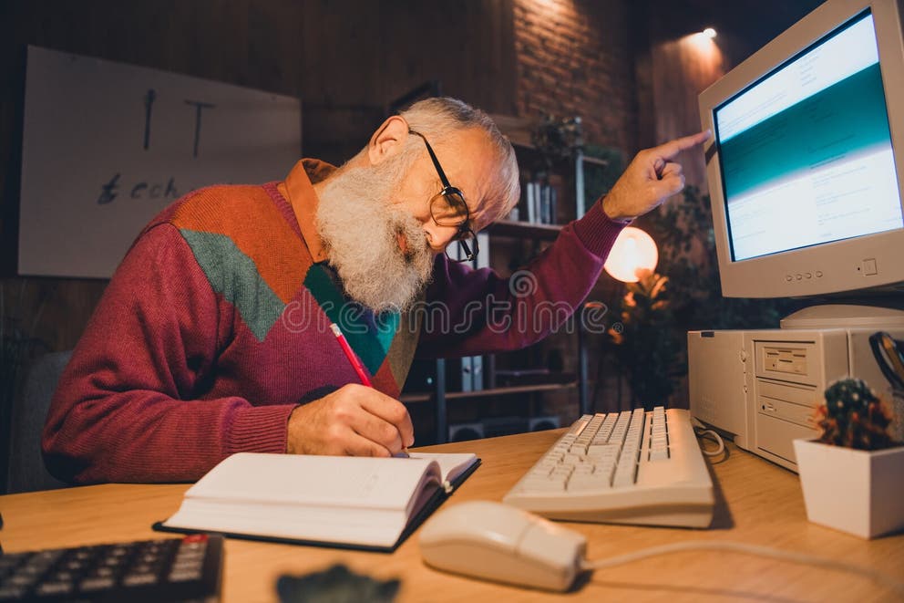 Elderly Programmer Working Attentively at His Desk in Cozy Evening ...