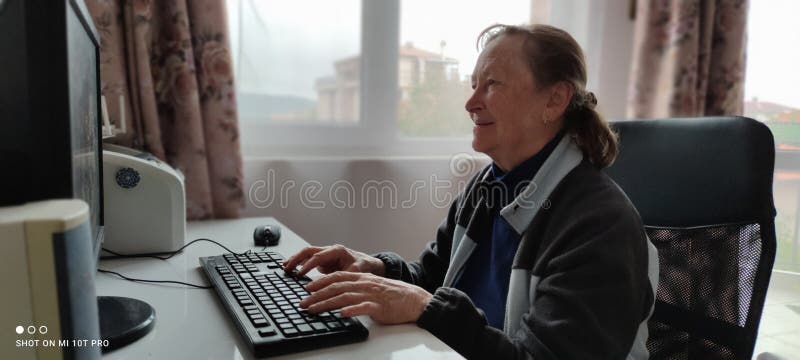 Elderly Smiling Woman Working on Computer at Home Stock Photo - Image ...