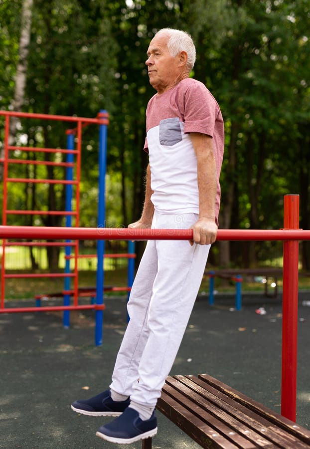 Elderly Sportive Man Doing Parallel Bars Exercise in Park Stock Photo ...
