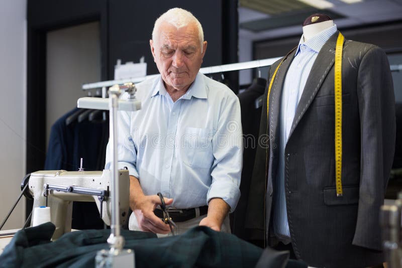 Elderly Tailor Cuts Fabric with Scissors at Workplace in Workshop Stock ...