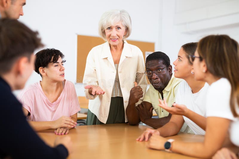 Elderly Teacher, Together with Students of Different Ages, Conducts ...